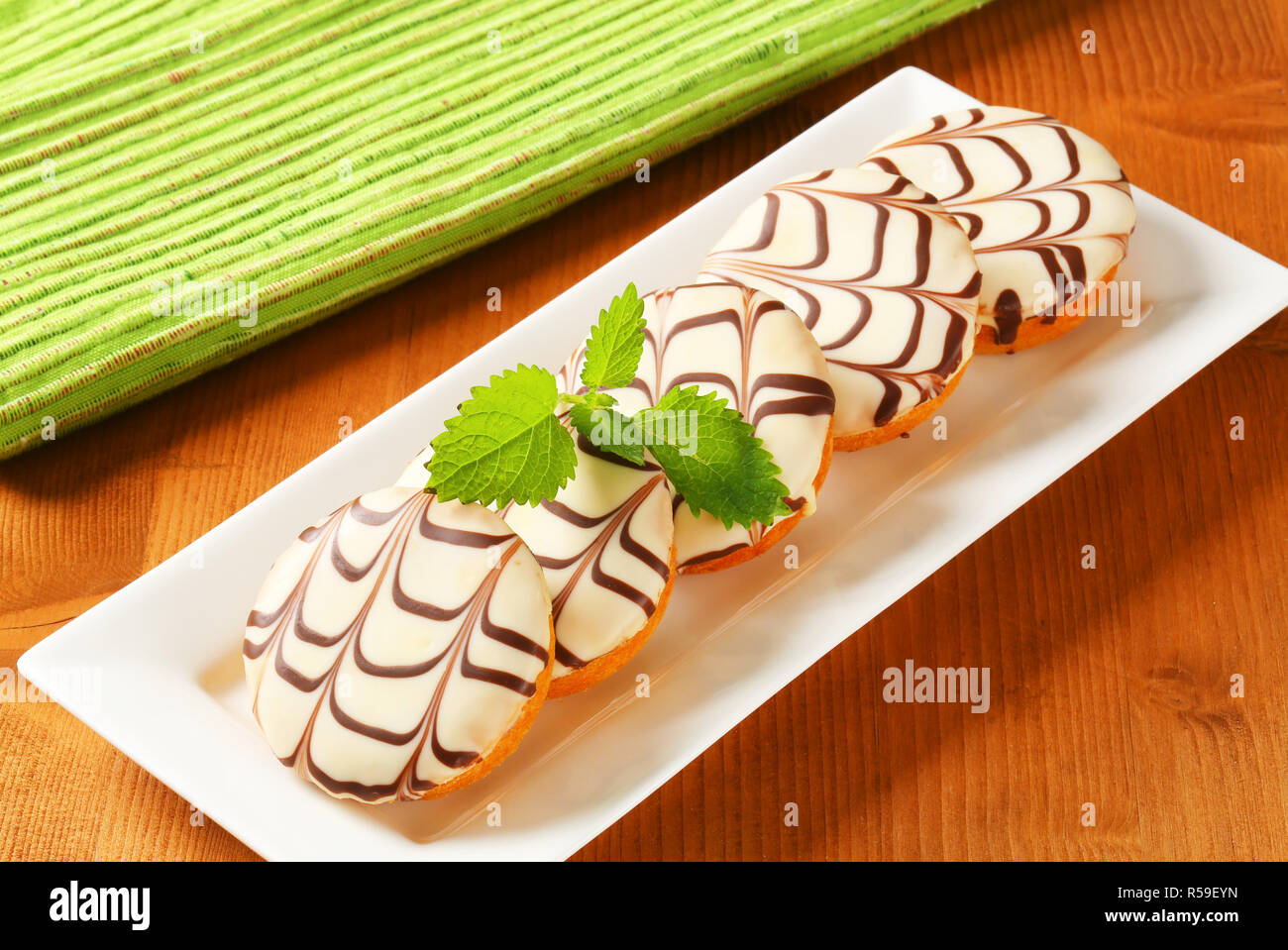 Chocolate-glazed mini cakes Stock Photo - Alamy