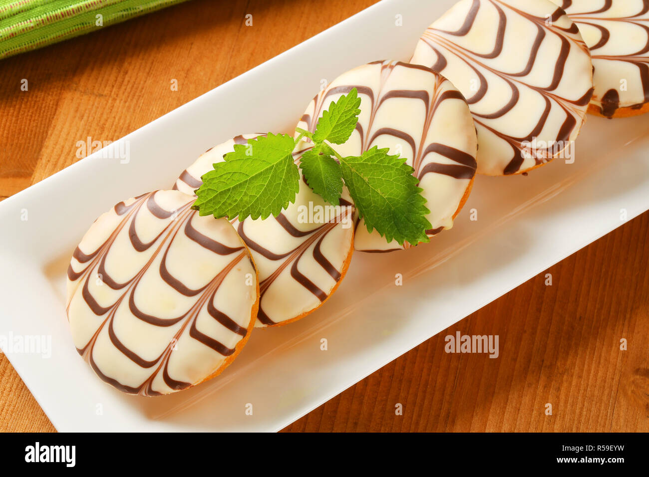 Chocolate-glazed mini cakes Stock Photo - Alamy
