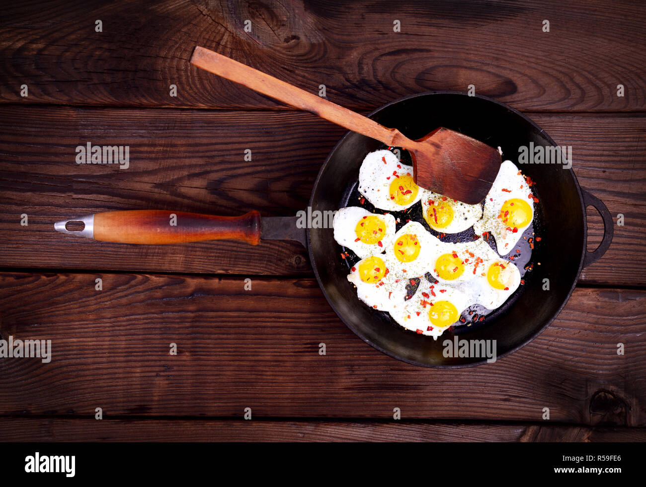 Fried quail eggs in a black frying pan Stock Photo - Alamy