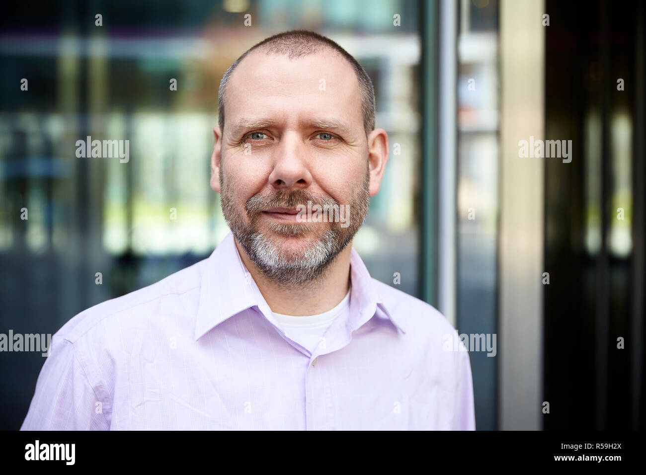 Man in front of office building Stock Photo - Alamy