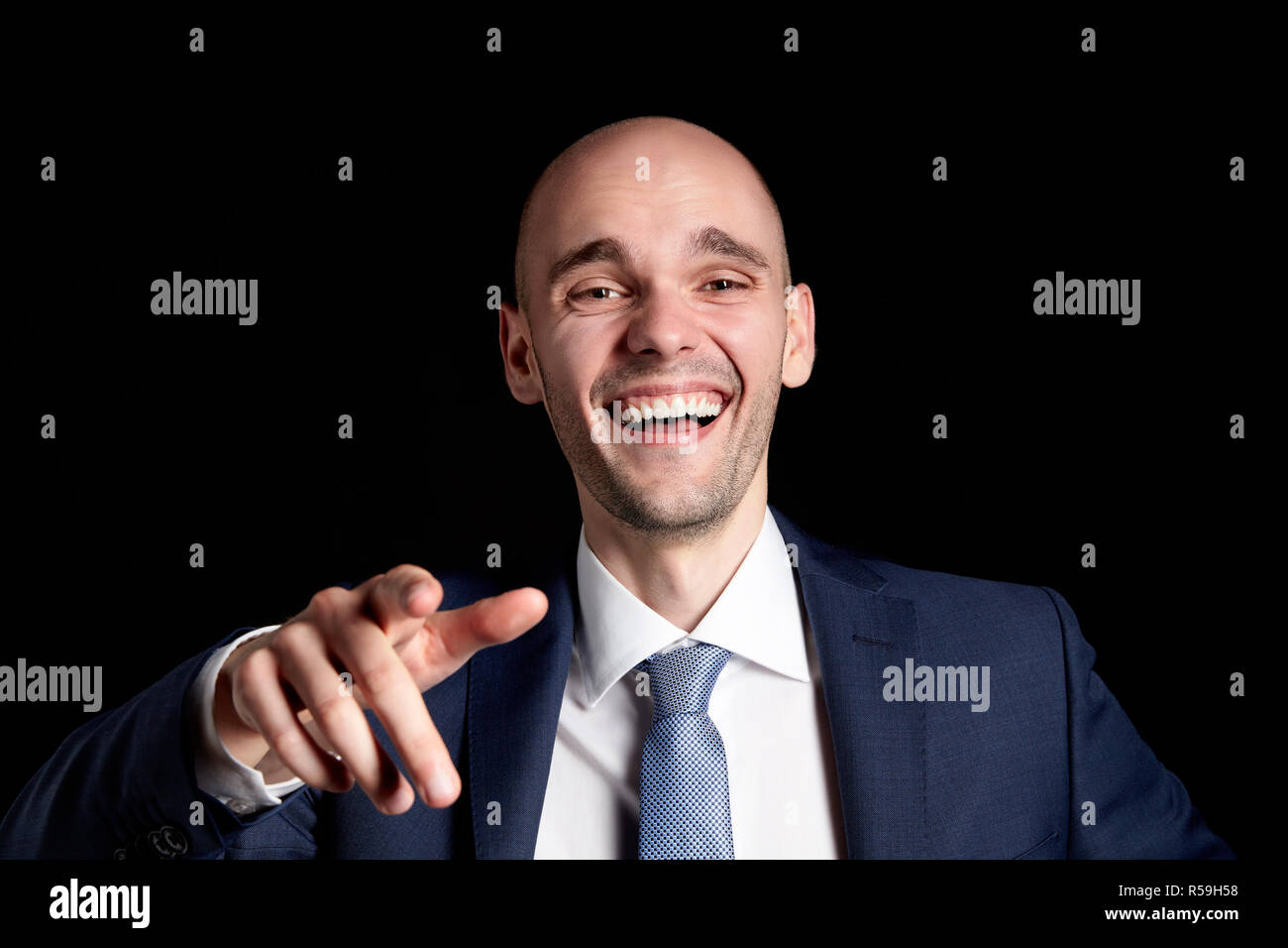 Laughing Businessman Pointing his Finger Stock Photo - Alamy