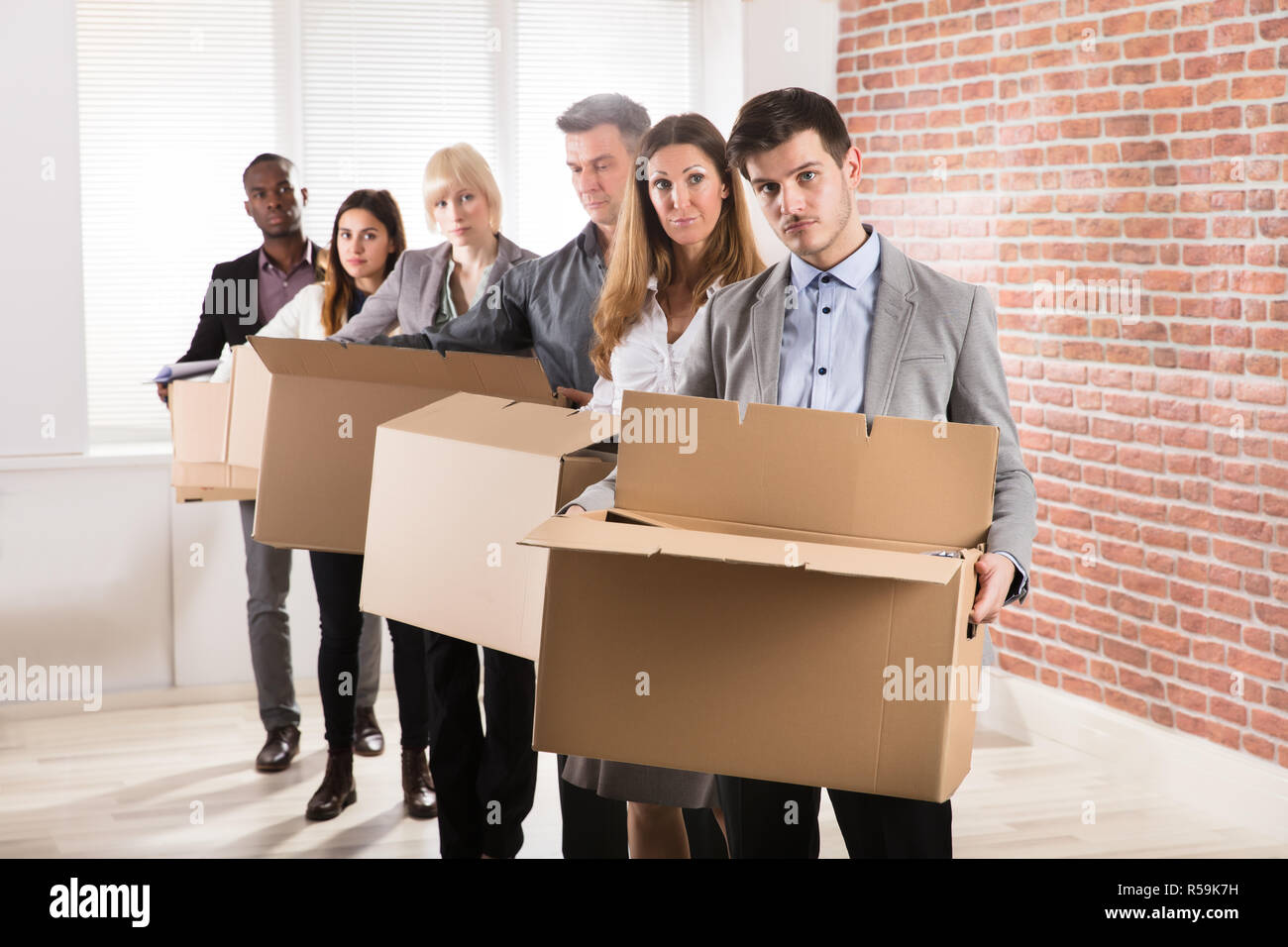 Sad man standing boxes hi-res stock photography and images - Alamy