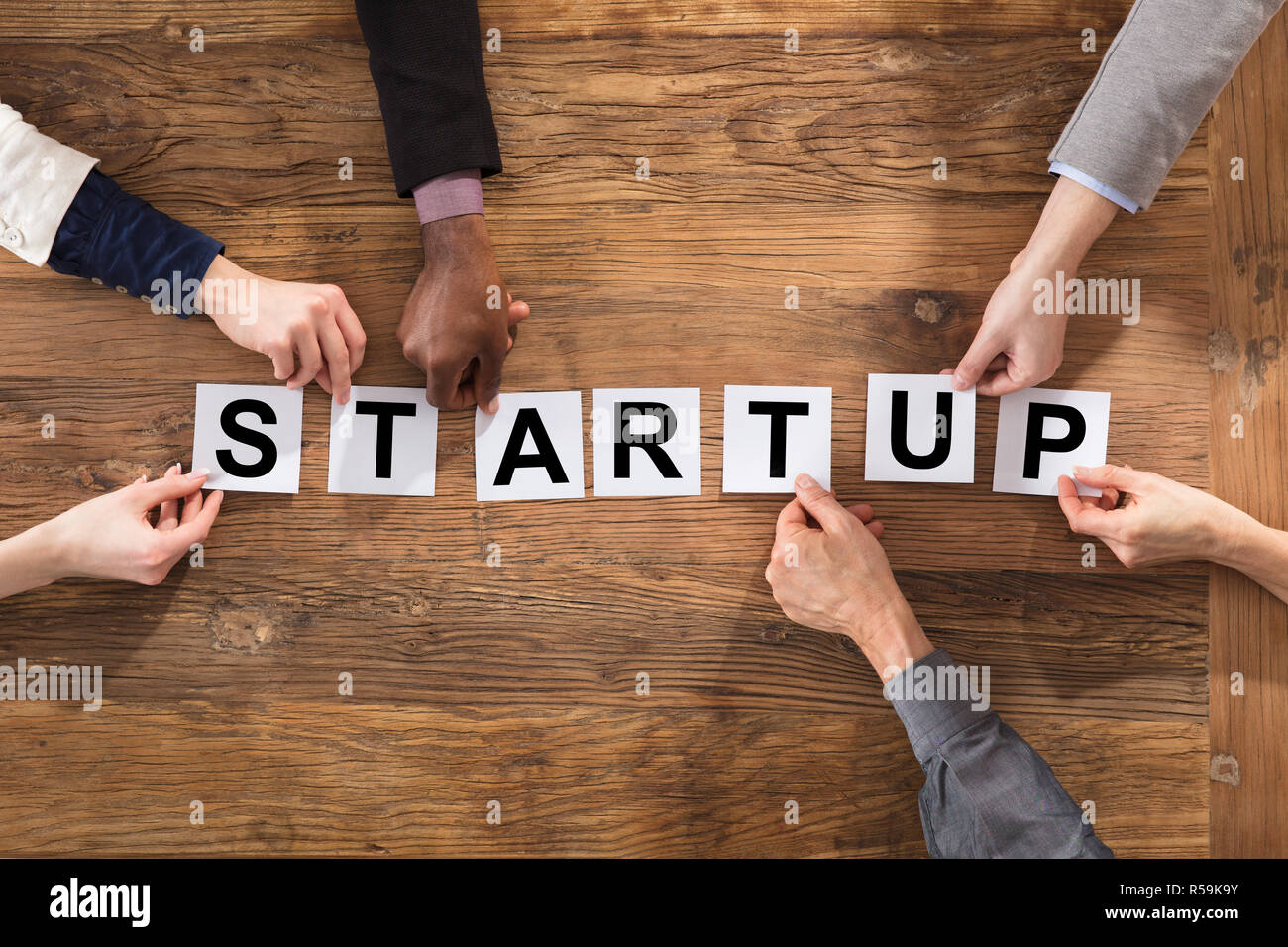 Businesspeople Hands Arranging Start Up Word Stock Photo - Alamy