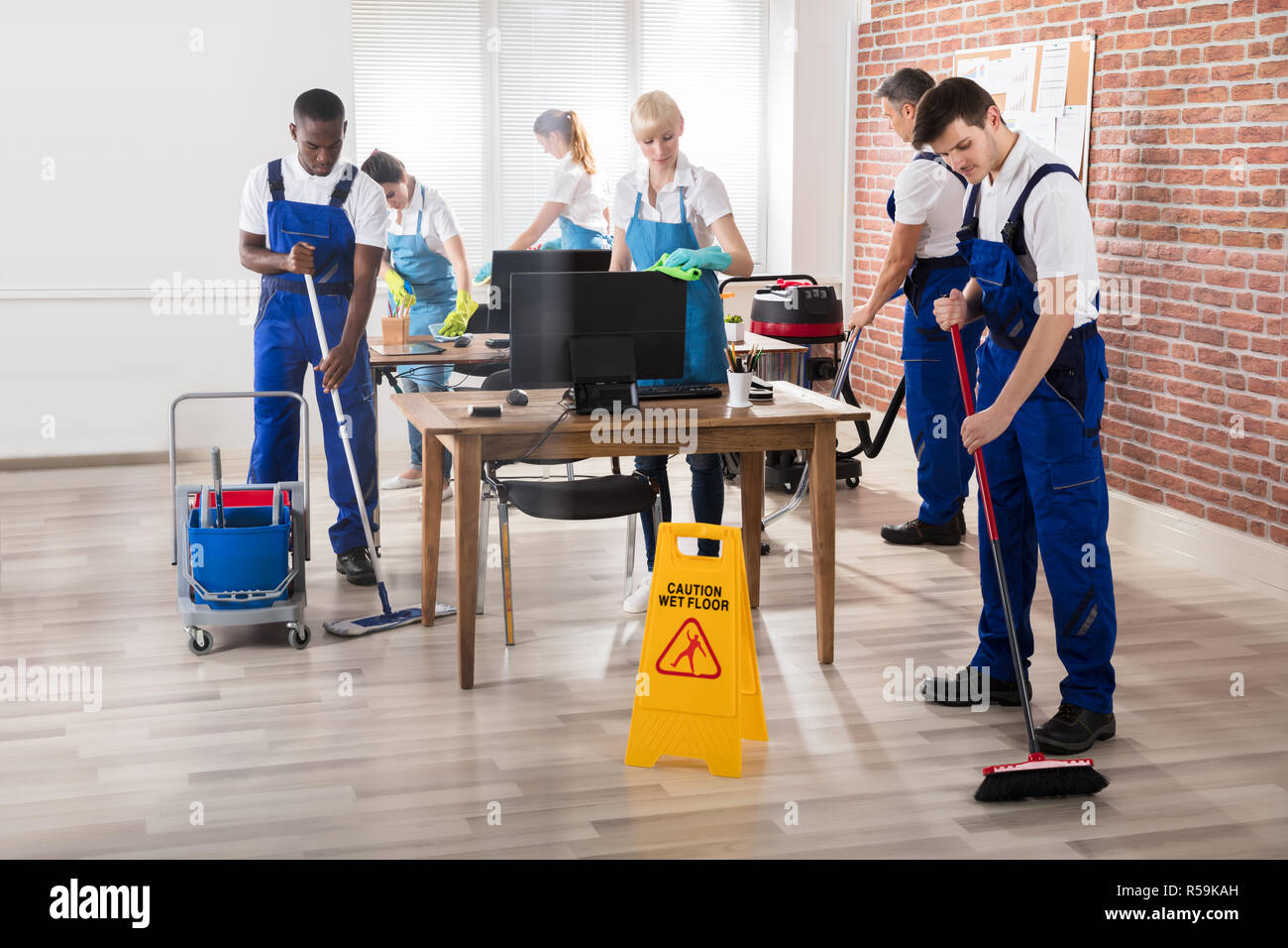 Janitors Cleaning The Office Stock Photo - Alamy