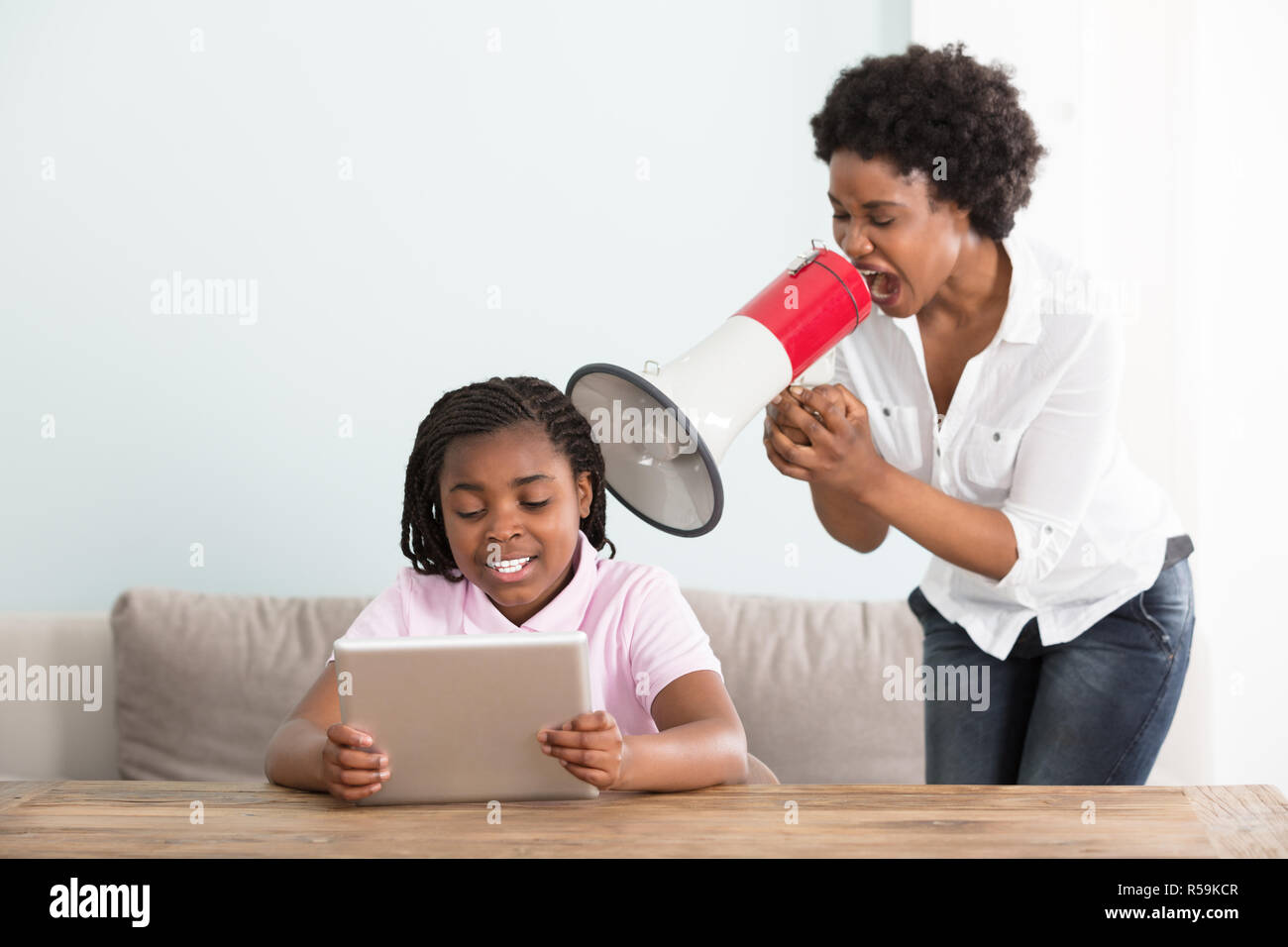 Mother Shouts At Her Daughter In A Megaphone Stock Photo - Alamy