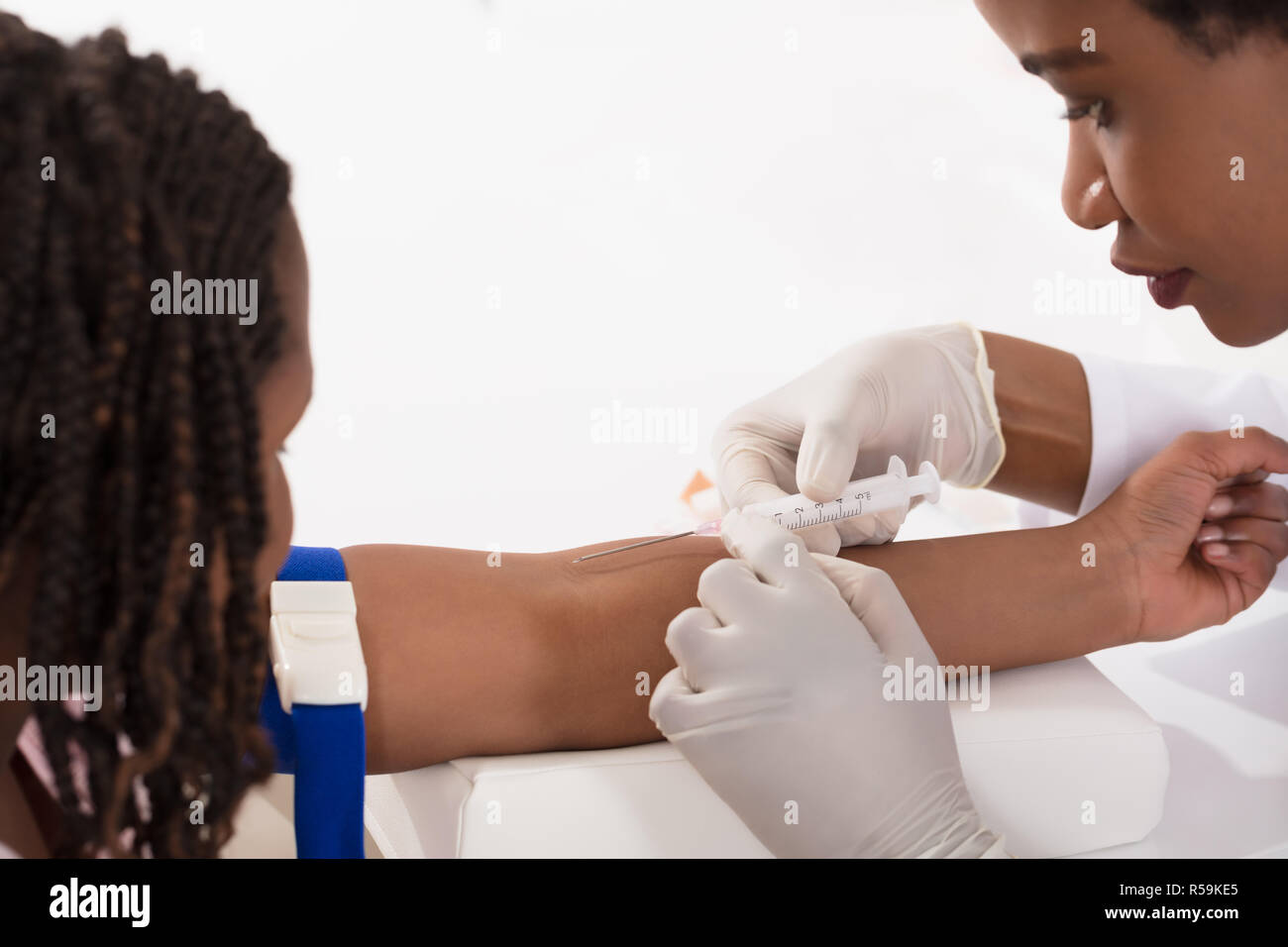 Doctor Injecting Patient With Syringe To Collect Blood Stock Photo - Alamy