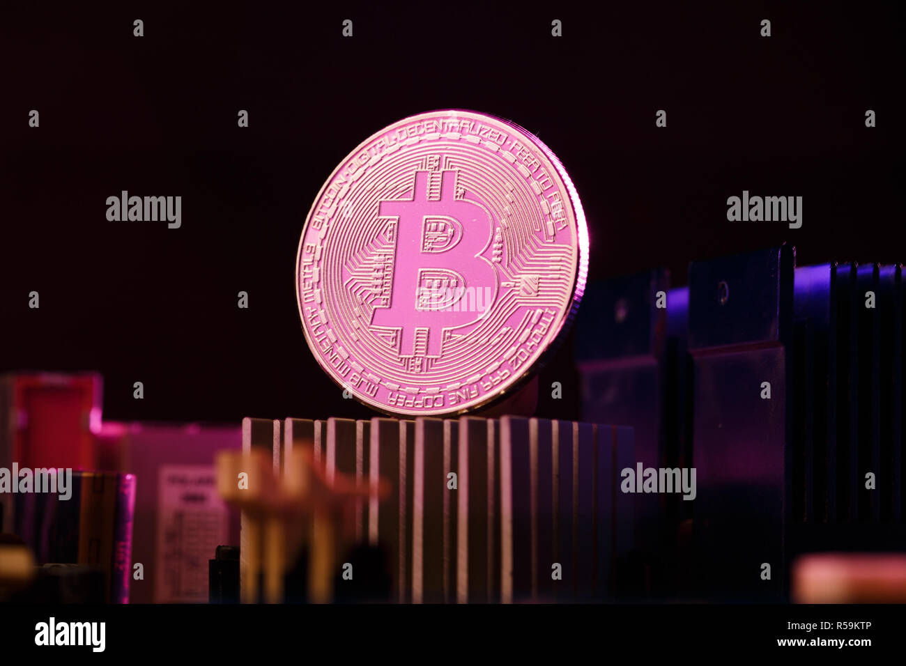 Picture of bitcoin and processor on pink background Stock Photo - Alamy