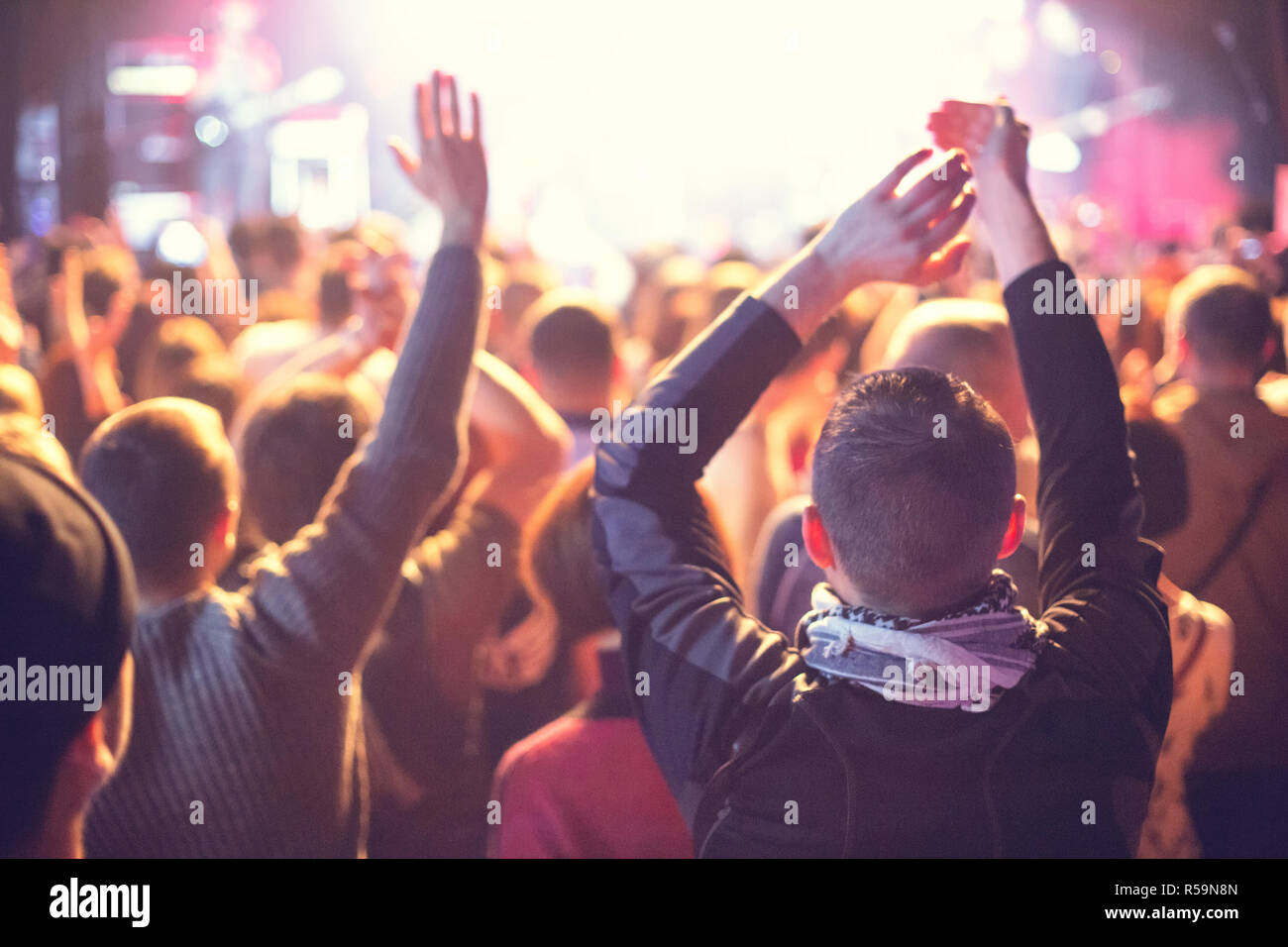 A concert crowd of people applauds the artist on stage Stock Photo - Alamy