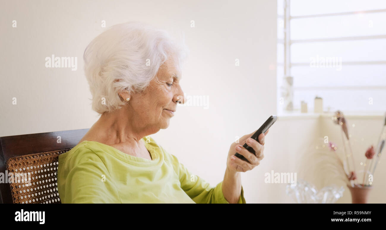 Happy Old Woman Using Mobile Phone For Leisure Stock Photo - Alamy