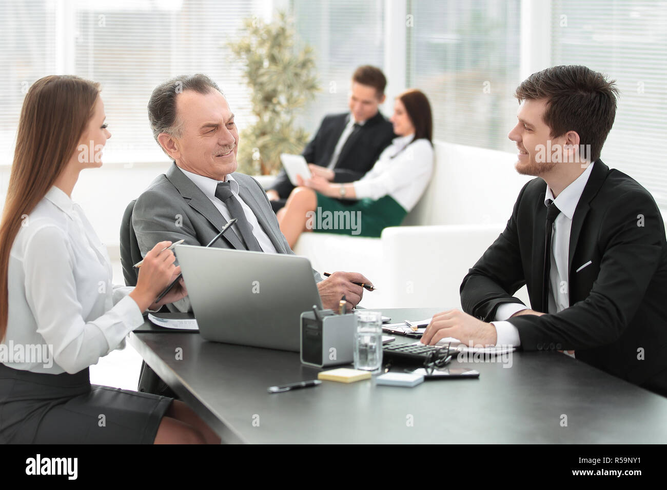 client talking with the staff at the Desk in the office Stock Photo - Alamy