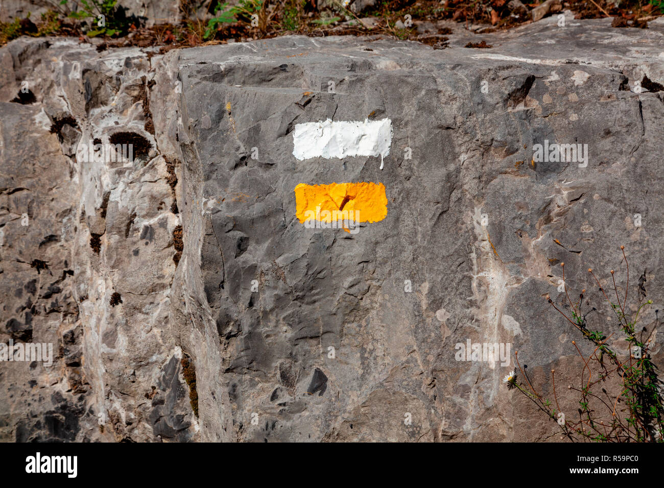 European signage of roads, trails and mountain routes. White and yellow ...