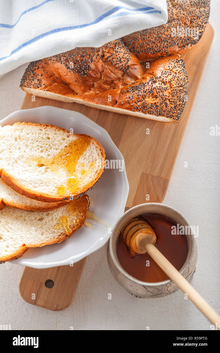 Braided Challah bread and honey Stock Photo - Alamy