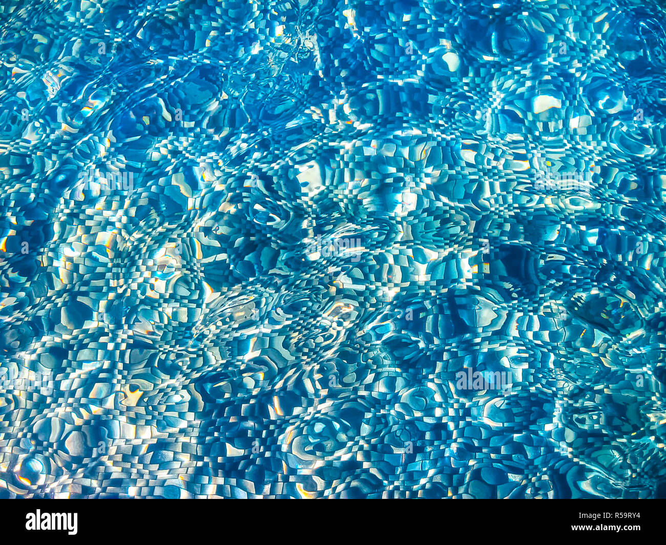 Blue pool water with sun reflections Stock Photo - Alamy