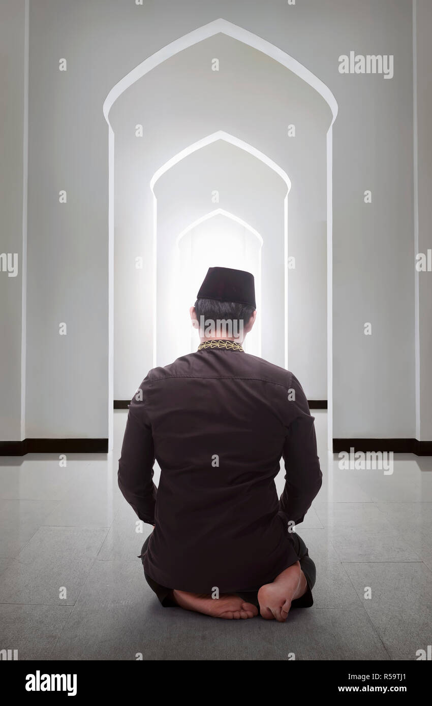 Back view of muslim man with cap praying Stock Photo - Alamy