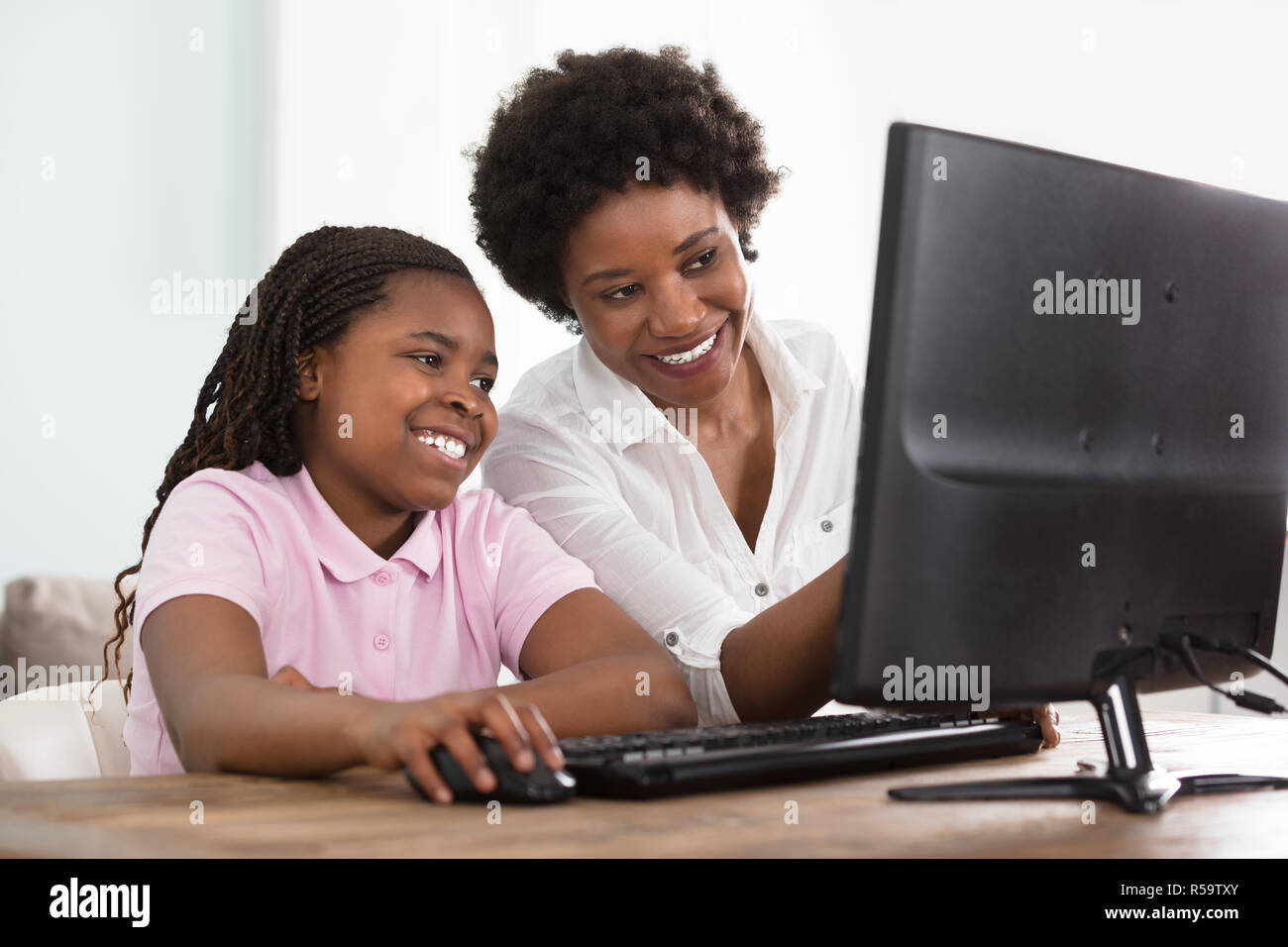 Mother And Daughter Using Computer Stock Photo - Alamy