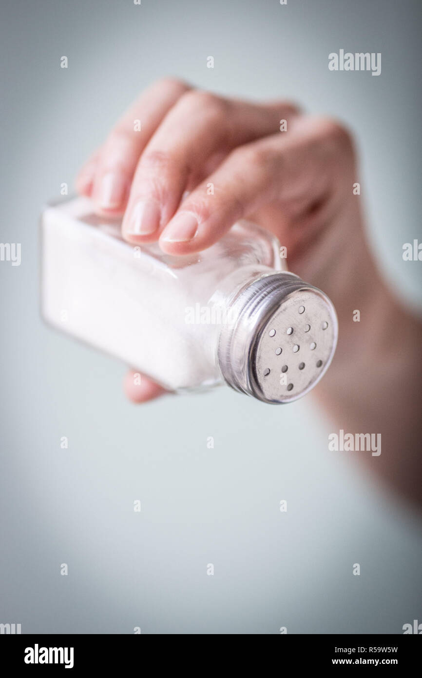 Woman add salt to food hi-res stock photography and images - Alamy