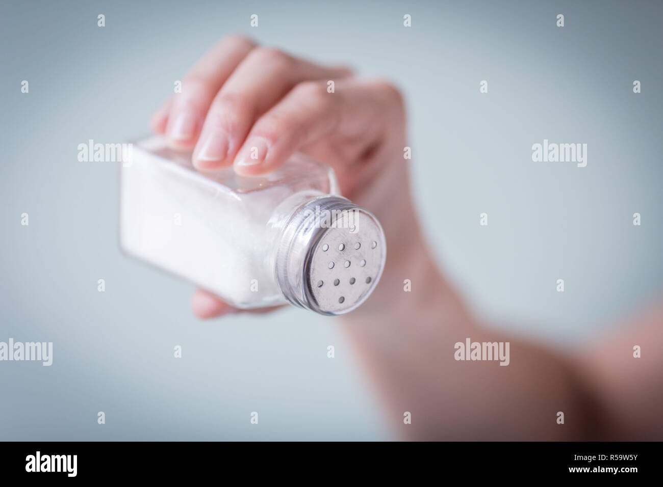 Woman add salt to food hi-res stock photography and images - Alamy