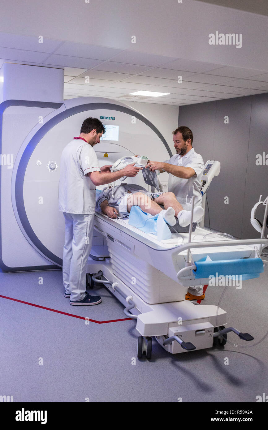 Patient in an MRI (magnetic resonance imaging) scanner, MRI of the ...