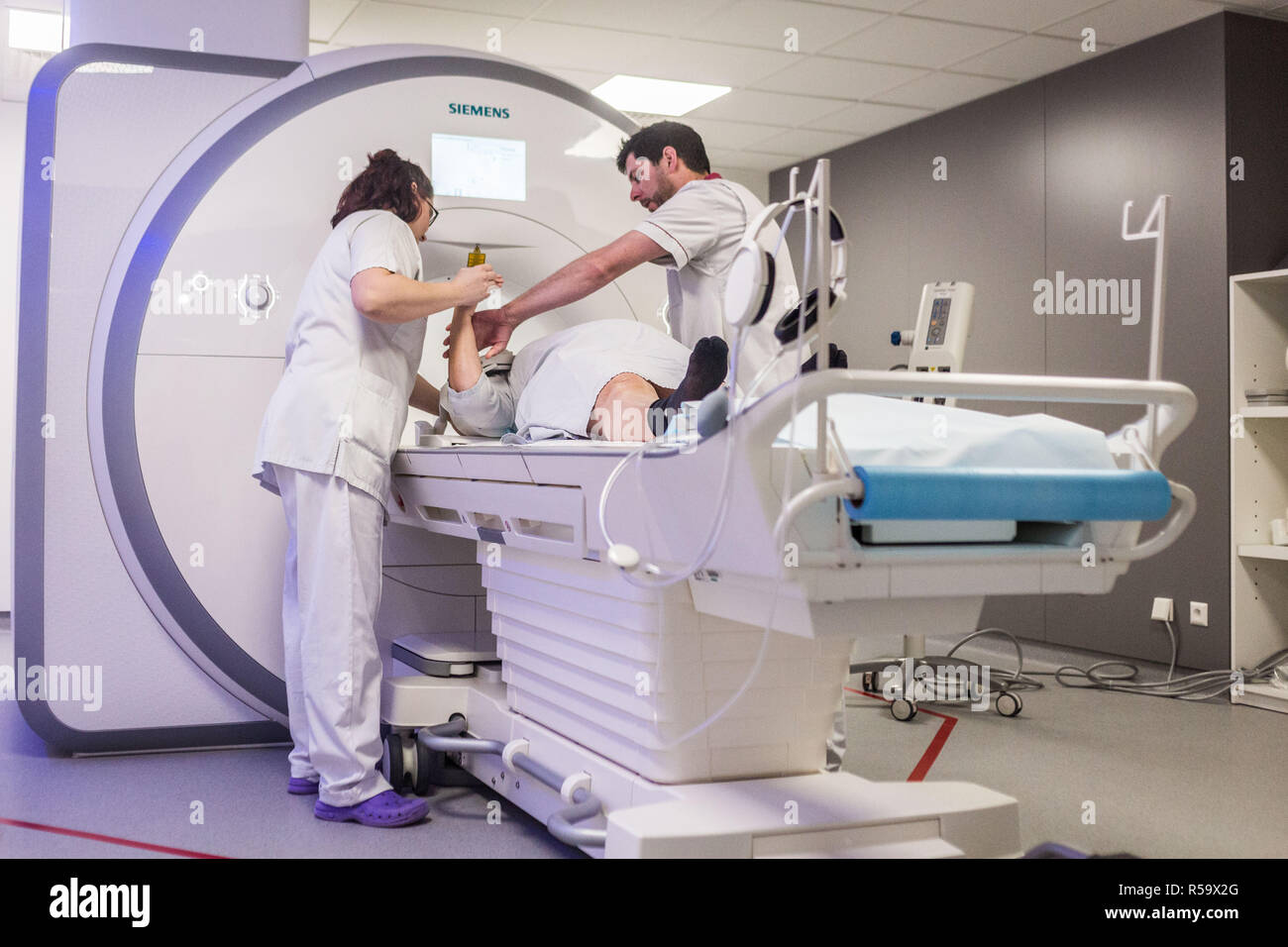 Patient in an MRI (magnetic resonance imaging) scanner, MRI of the ...