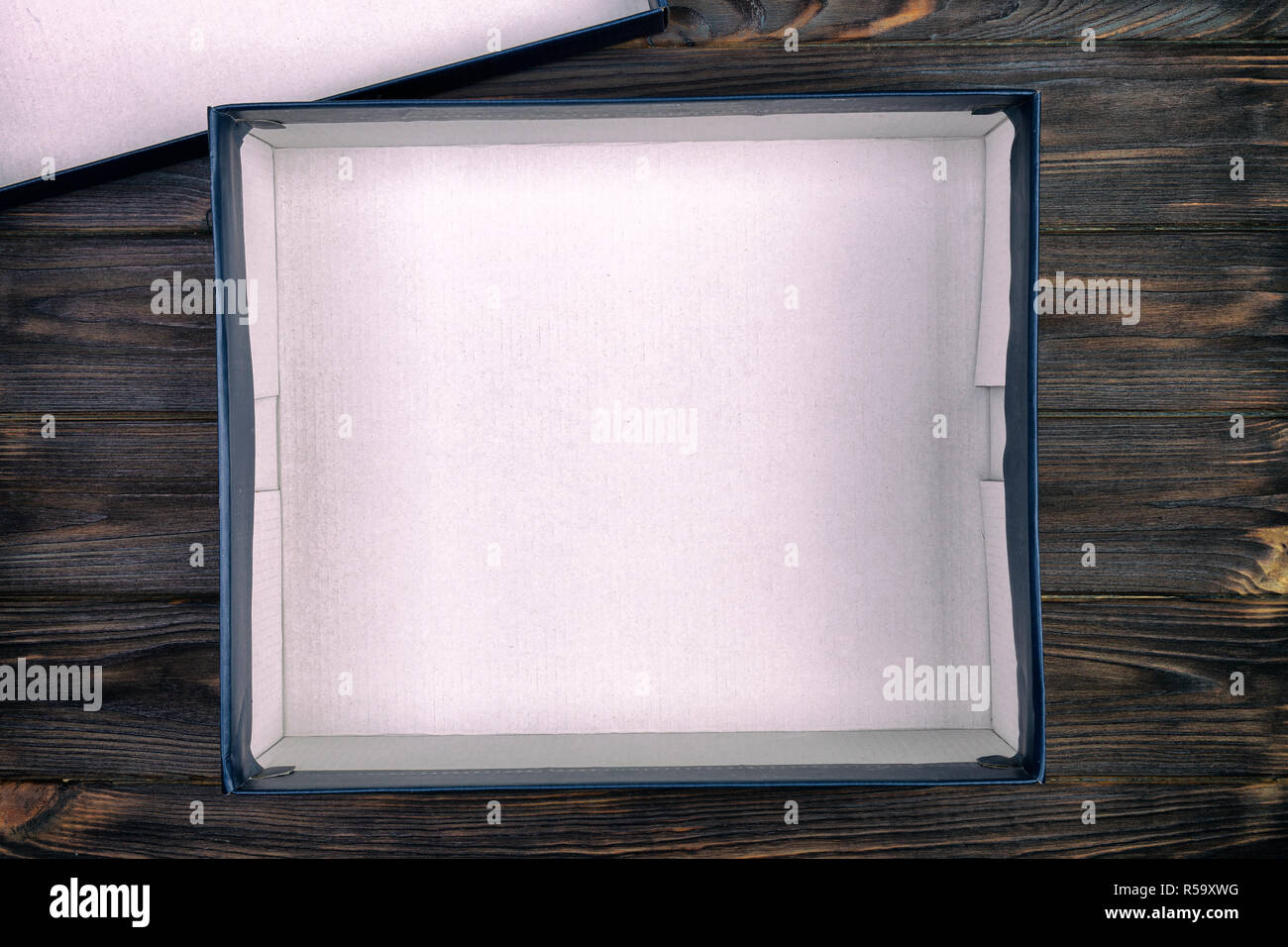 Open Cardboard white box on a dark table, wooden background. vintage ...