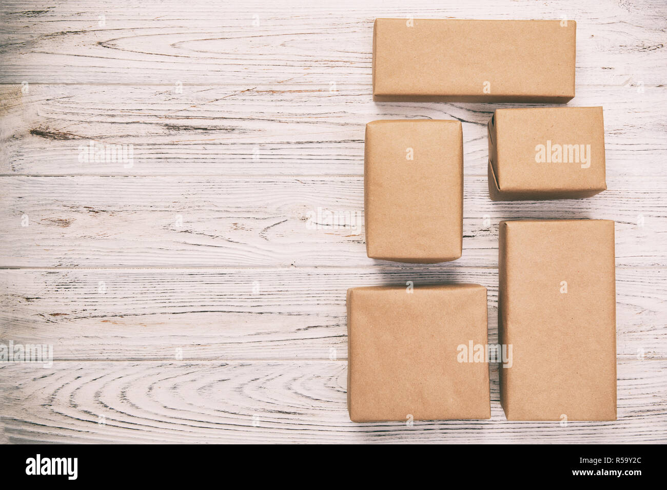 cardboard box on white wooden background, vintage, toned Brown mail ...