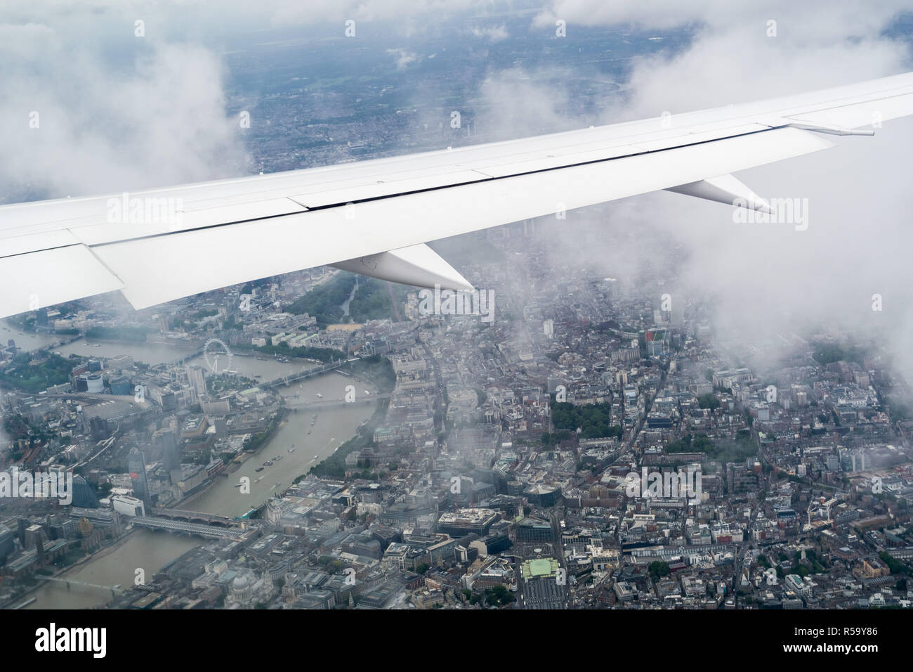 Airplane flying over London Stock Photo - Alamy