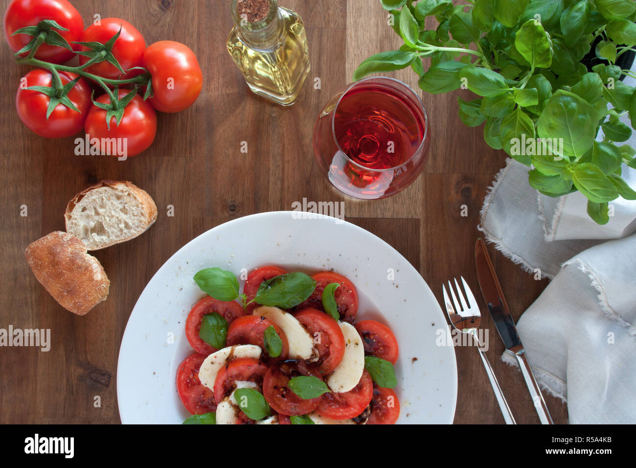 appetizer caprese with a glass of red wine Stock Photo - Alamy