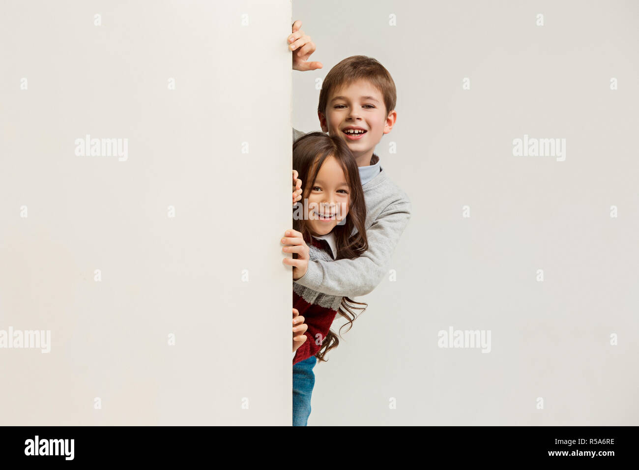 Banner with a surprised children peeking at the edge with copyspace ...