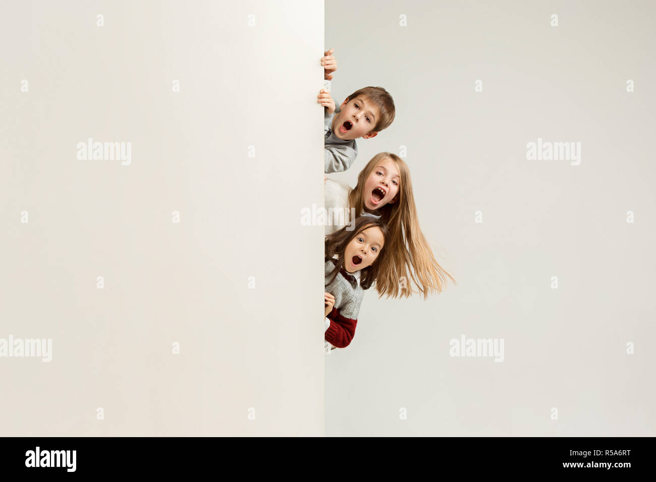 Banner with a surprised children peeking at the edge with copyspace ...