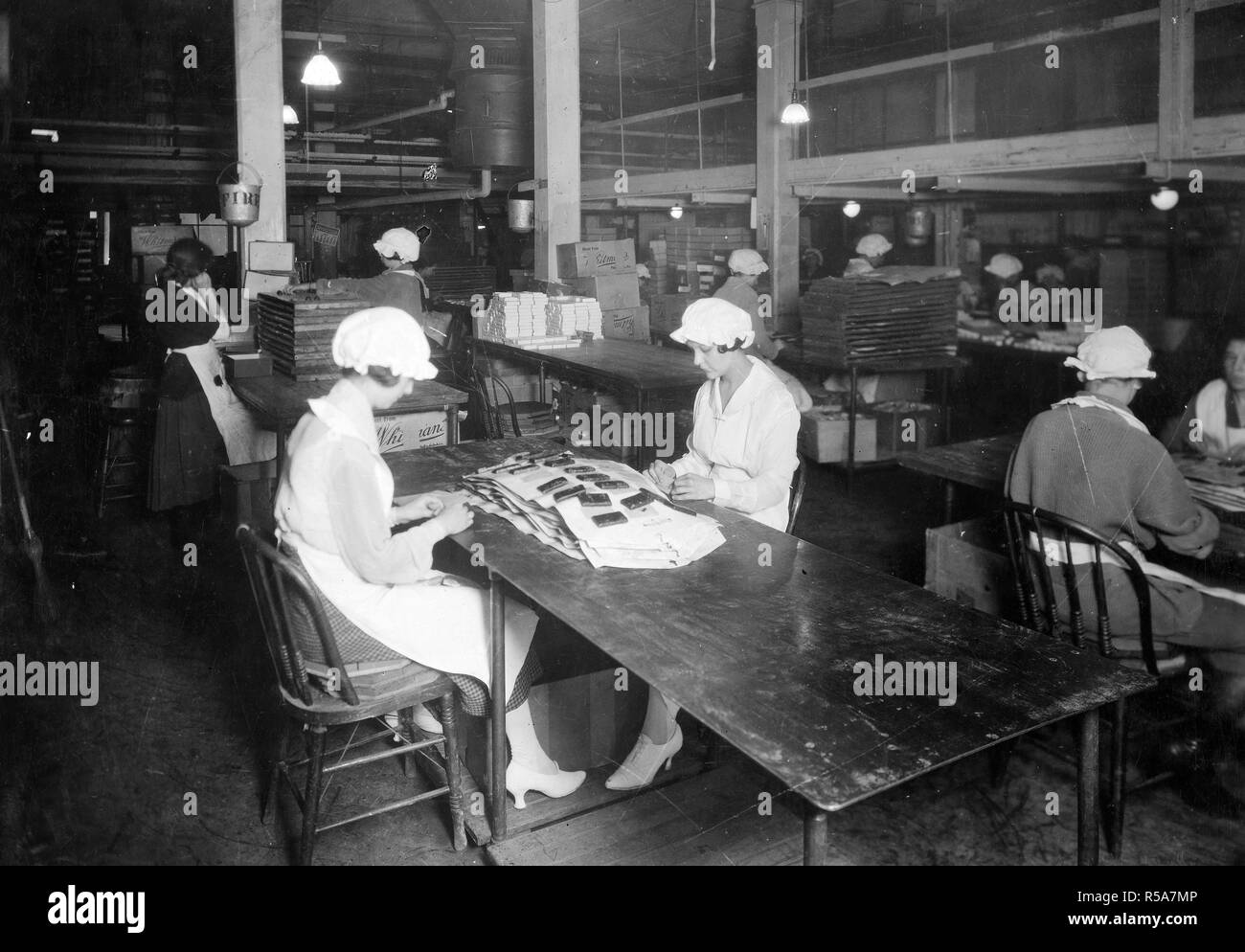 Hand packing chocolate covered cocoanut cream bars. The Whitman Candy ...