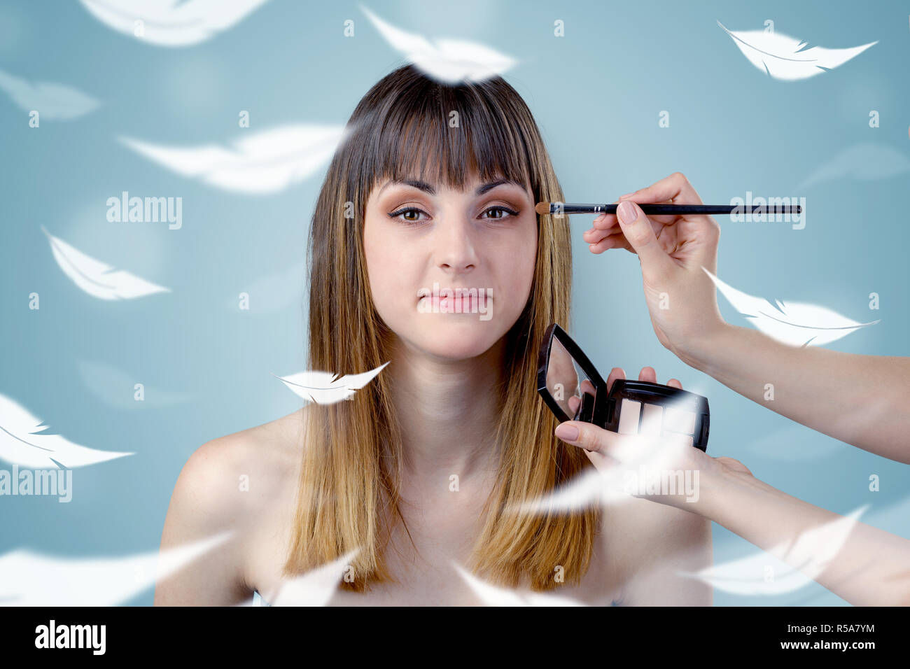 Pretty brunette woman at salon with plume around and ethereal concept ...
