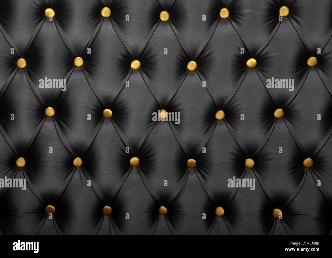 Black capitone with golden buttons texture Stock Photo - Alamy