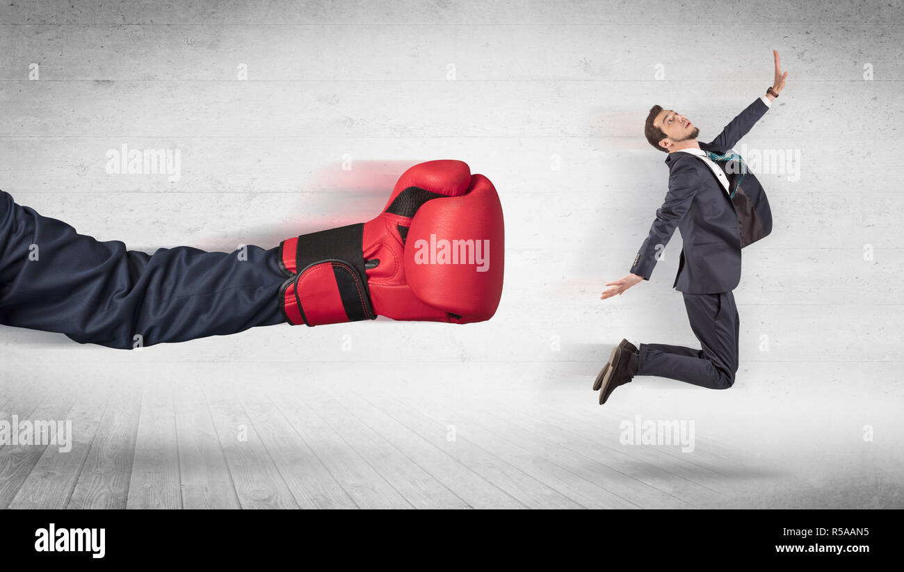 Arm with red boxing gloves hits office worker concept Stock Photo - Alamy