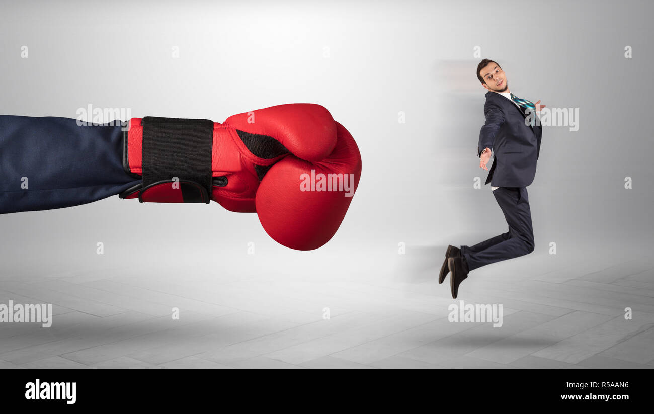 Giant hand gives a kick to a small employee businessman Stock Photo - Alamy