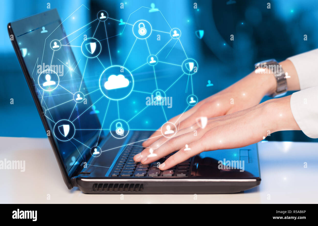 Hand using laptop with centralized cloud computing system and network security concept Stock ...