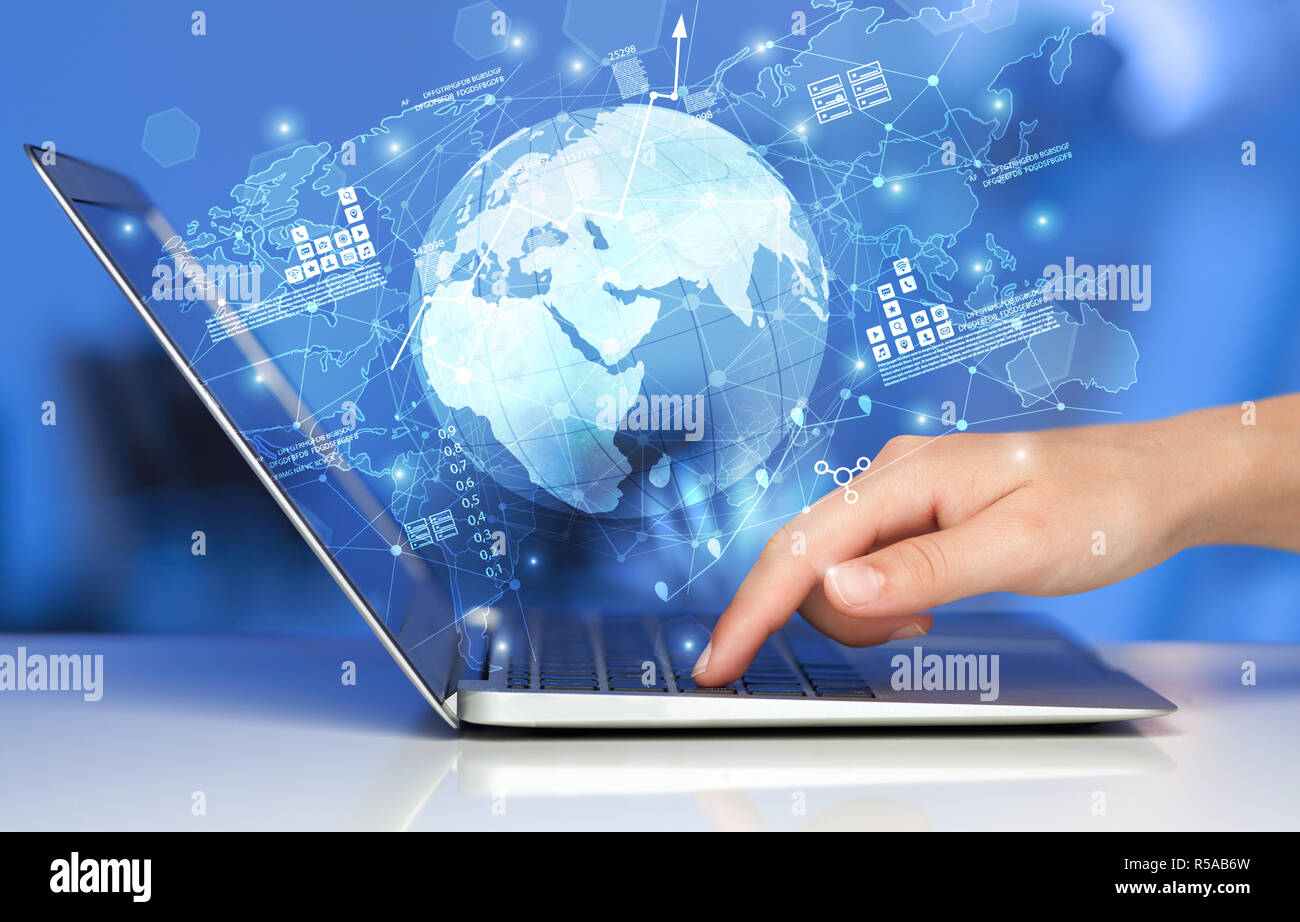 Hand using laptop with global reports and stock market change concept ...