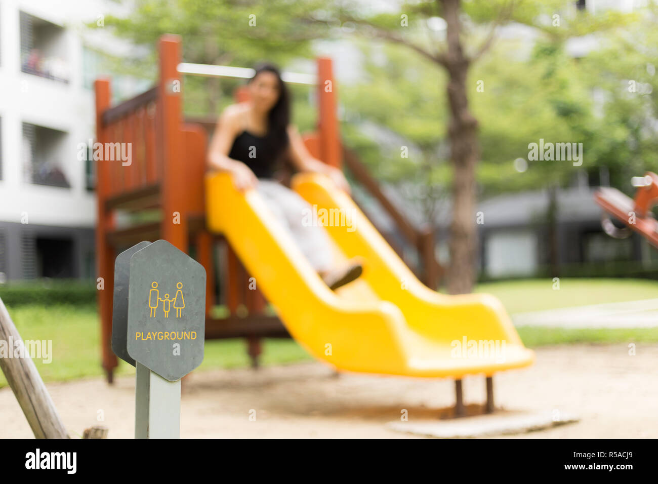 Children playground, yellow blue slider Stock Photo - Alamy