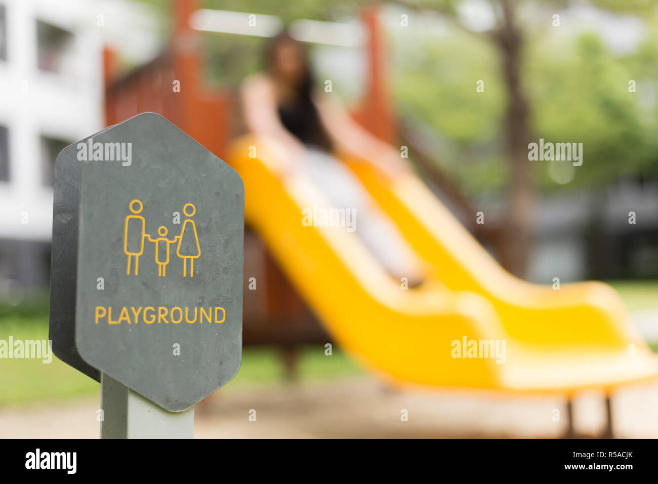 Children playground, yellow blue slider Stock Photo - Alamy