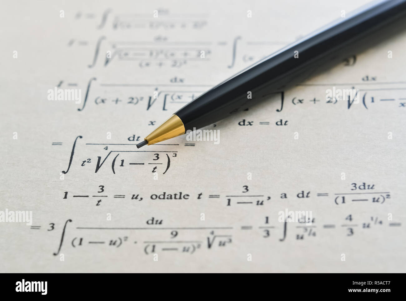 Pencil over a math book and advanced example with integrals Stock Photo ...
