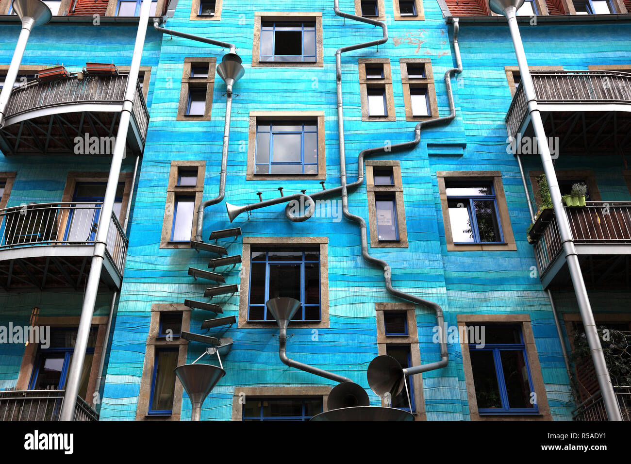 Blue house facade with rain pipes, art project for the element water ...