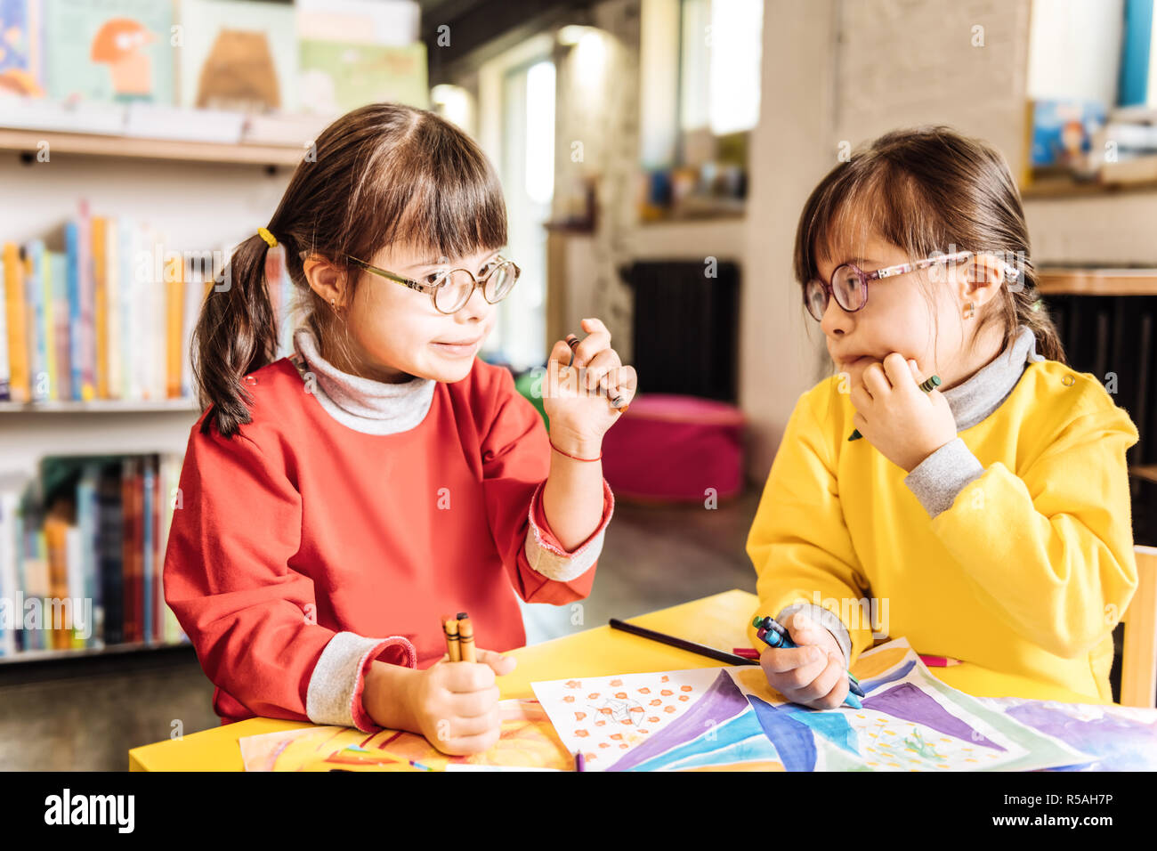 Light syndrome. Two cute preschool girls having light Down syndrome ...
