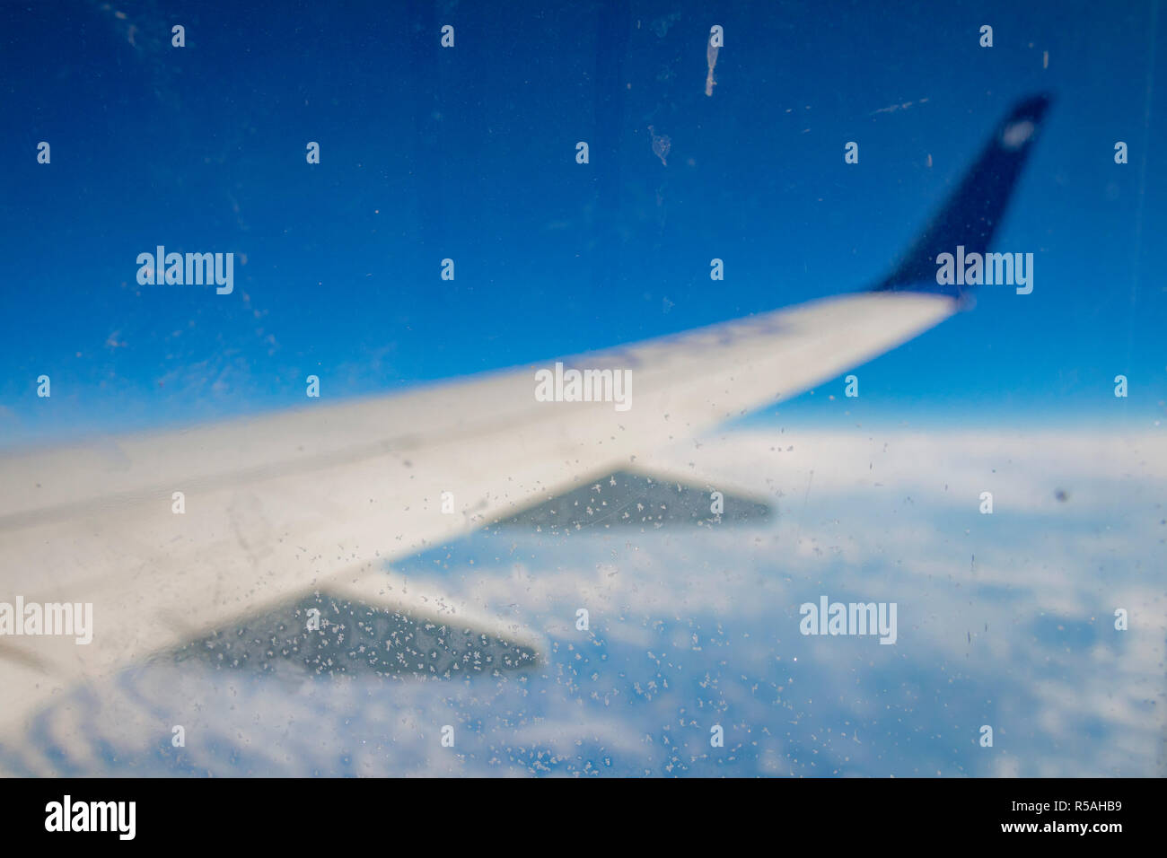 Frozen condensation of ice crystals on the window of an airplane with ...