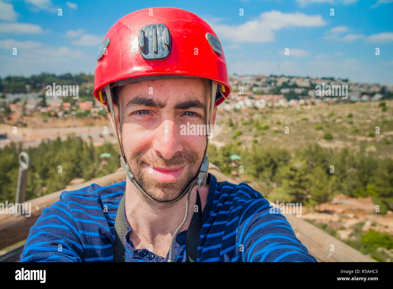Extreme professional climber taking selfie photo on the top of climbing ...