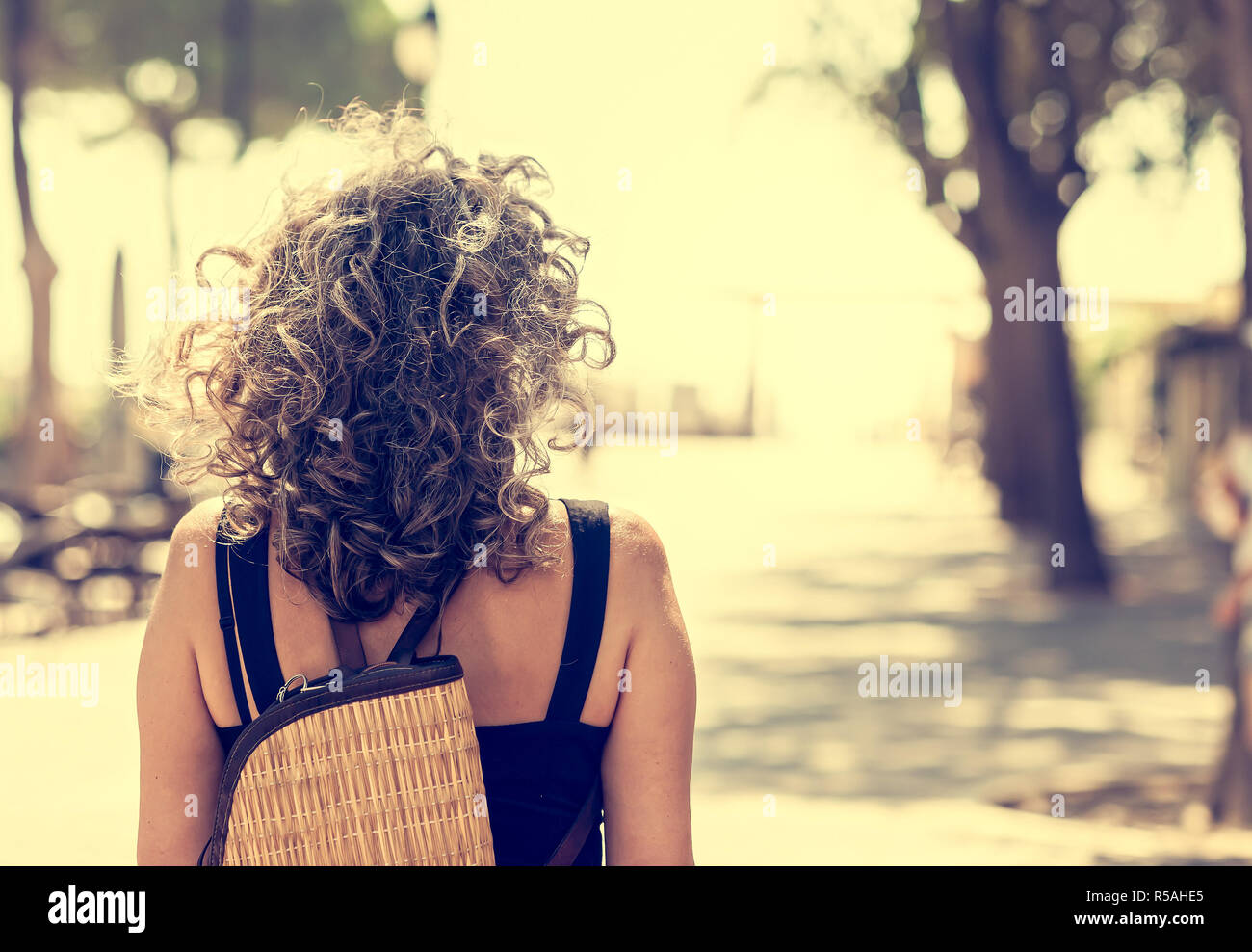 Woman seen from the back with blurry background Stock Photo - Alamy