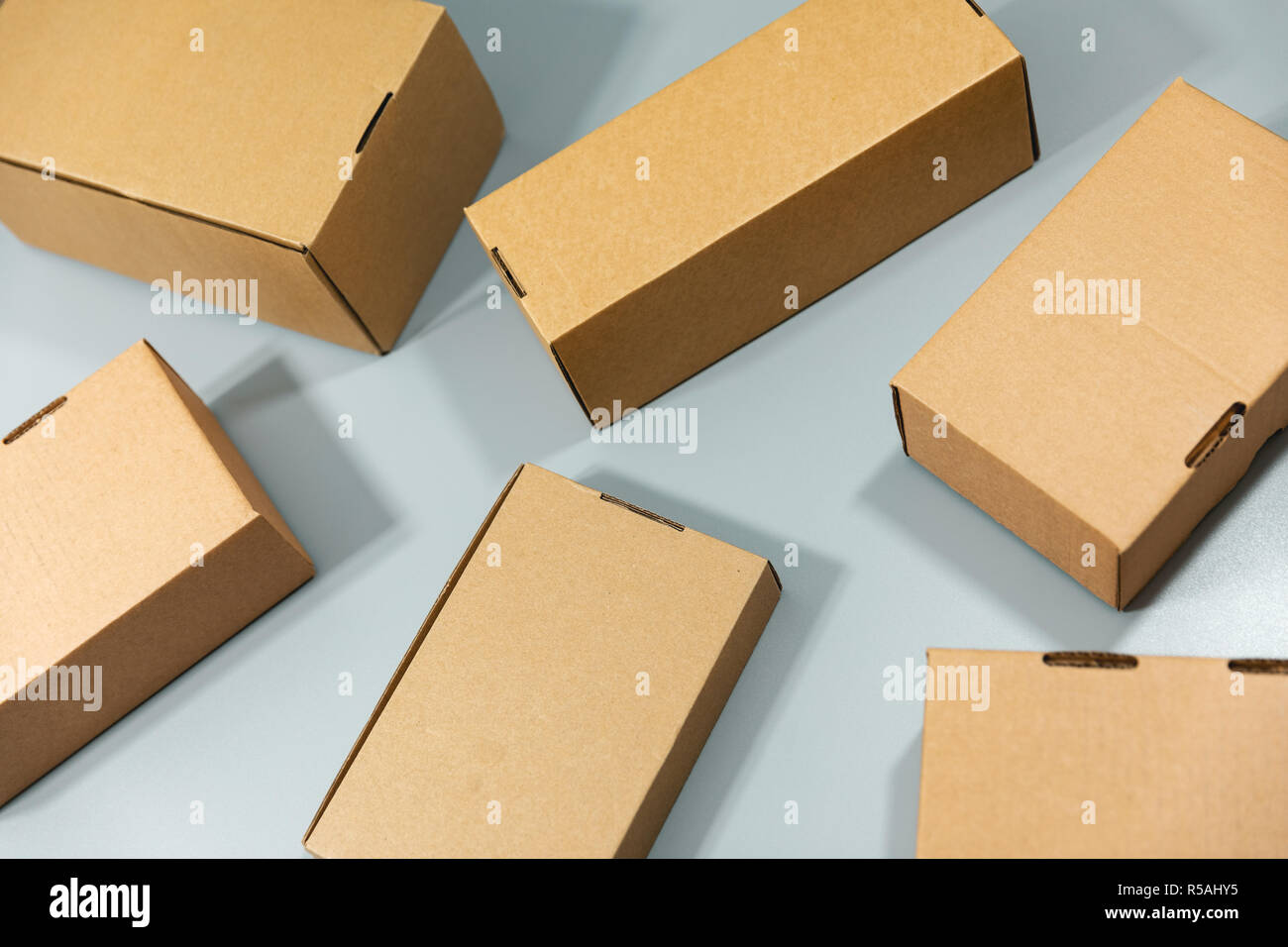 blank cardboard boxes on gray background Stock Photo - Alamy