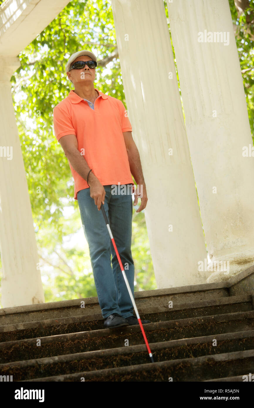 Blind Man Walking And Descending Stairs In City Park Stock Photo - Alamy