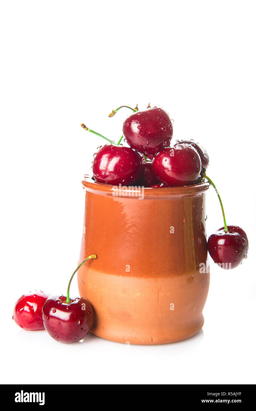 Pot with cherries isolated on a white background Stock Photo - Alamy