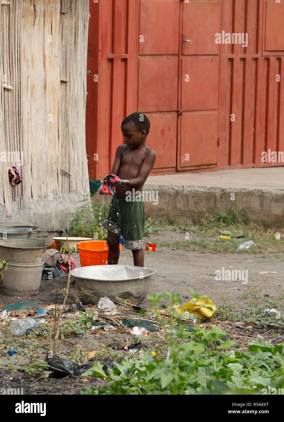 Children outside washing themselves and their clothes Stock Photo - Alamy