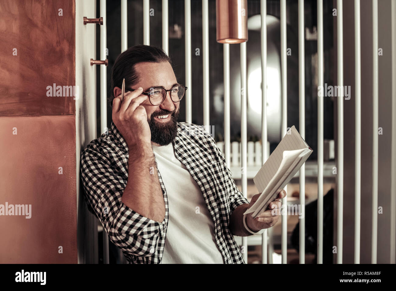 Professional businessman. Positive delighted man holding his notebook ...