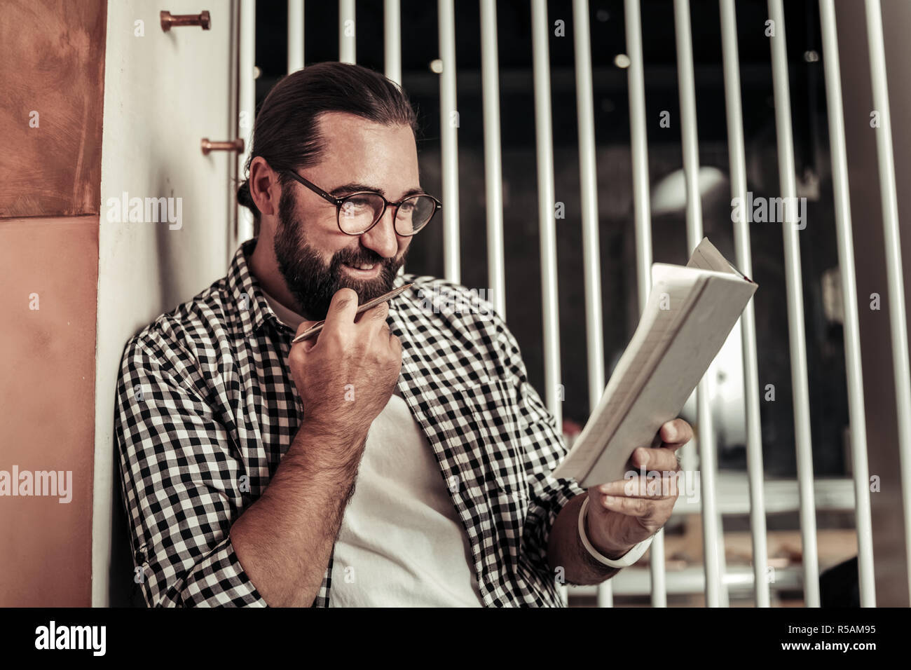 So busy schedule. Nice thoughtful man looking at his notes while ...
